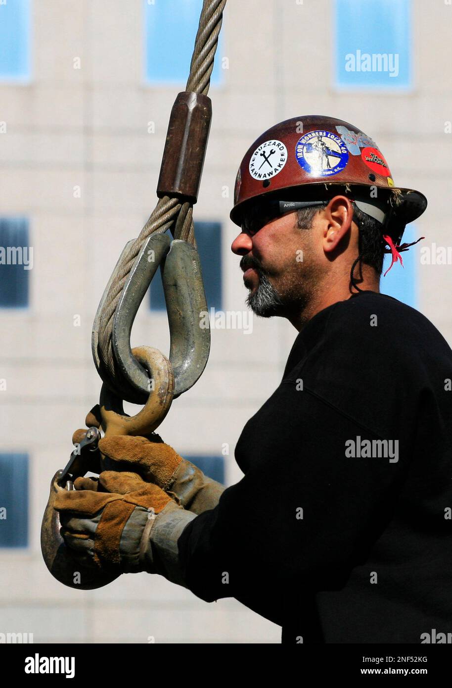 An ironworker moves a hoist cable for lifting steel at the World Trade ...