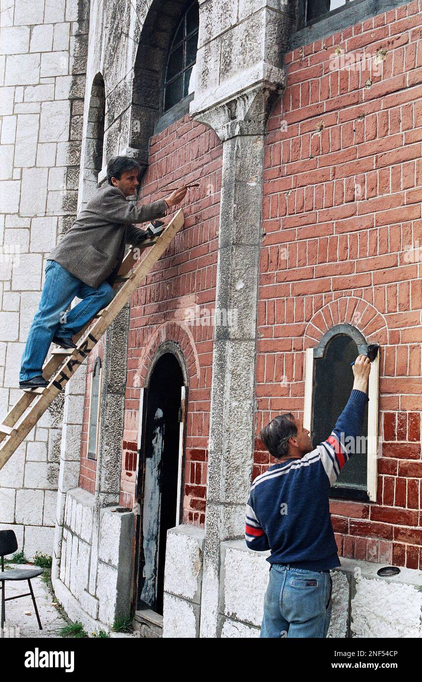 Two Muslim workers repair superficial damage to the Serbian Orthodox ...