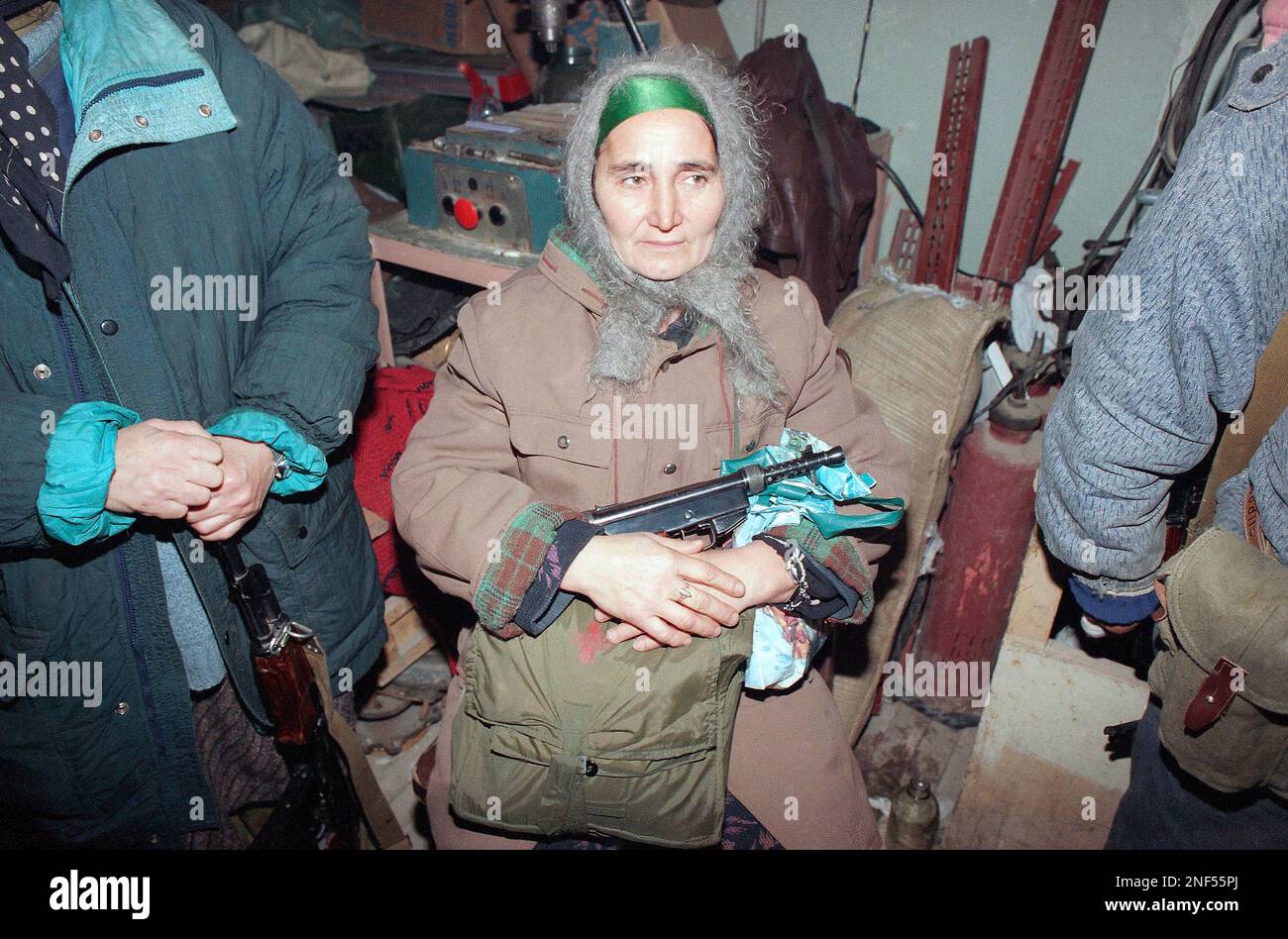 An armed Chechen woman defender waits in a bunker within the ...