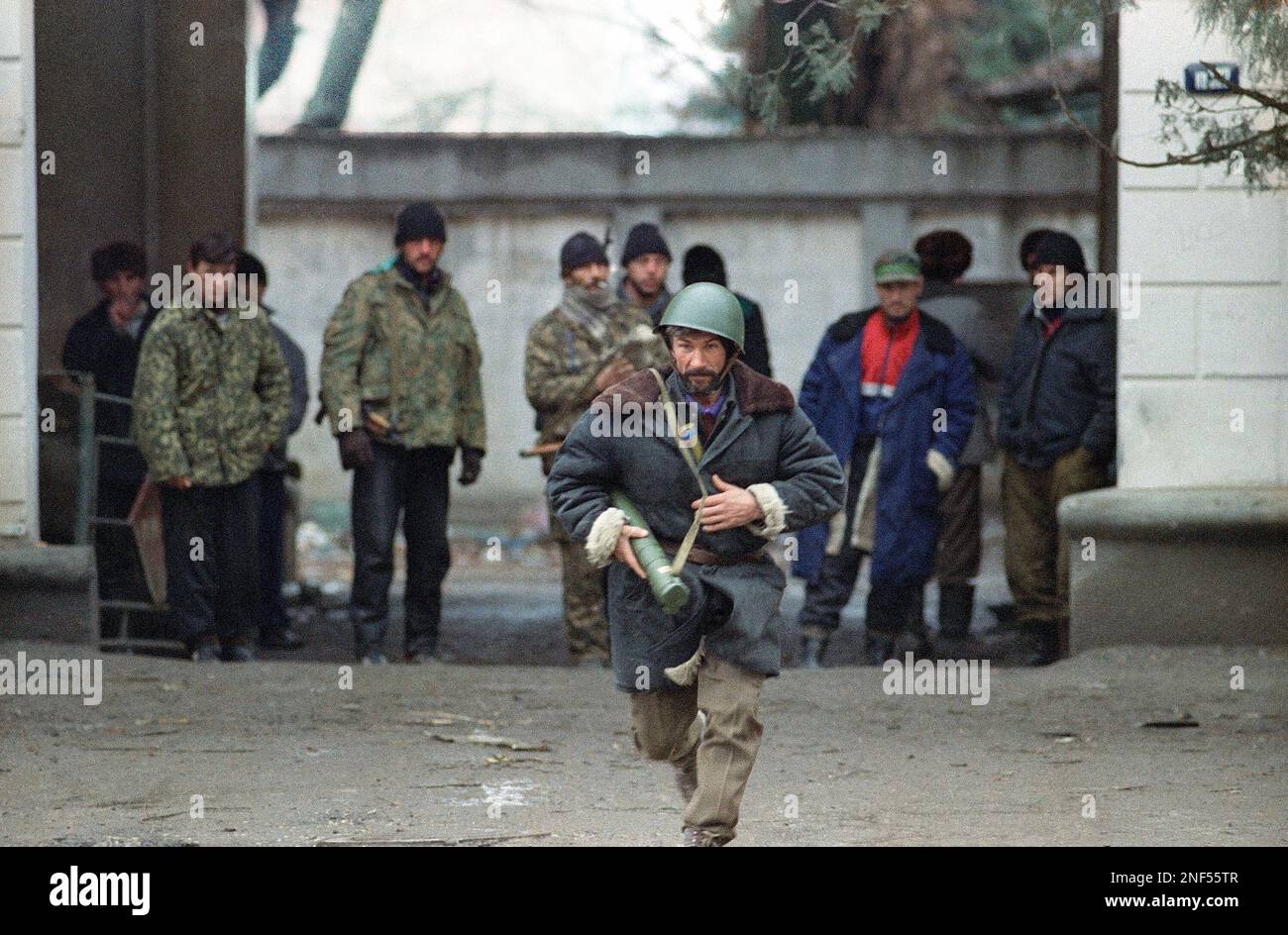 A Chechen fighter sprints across Leninsky Prospect near the ...