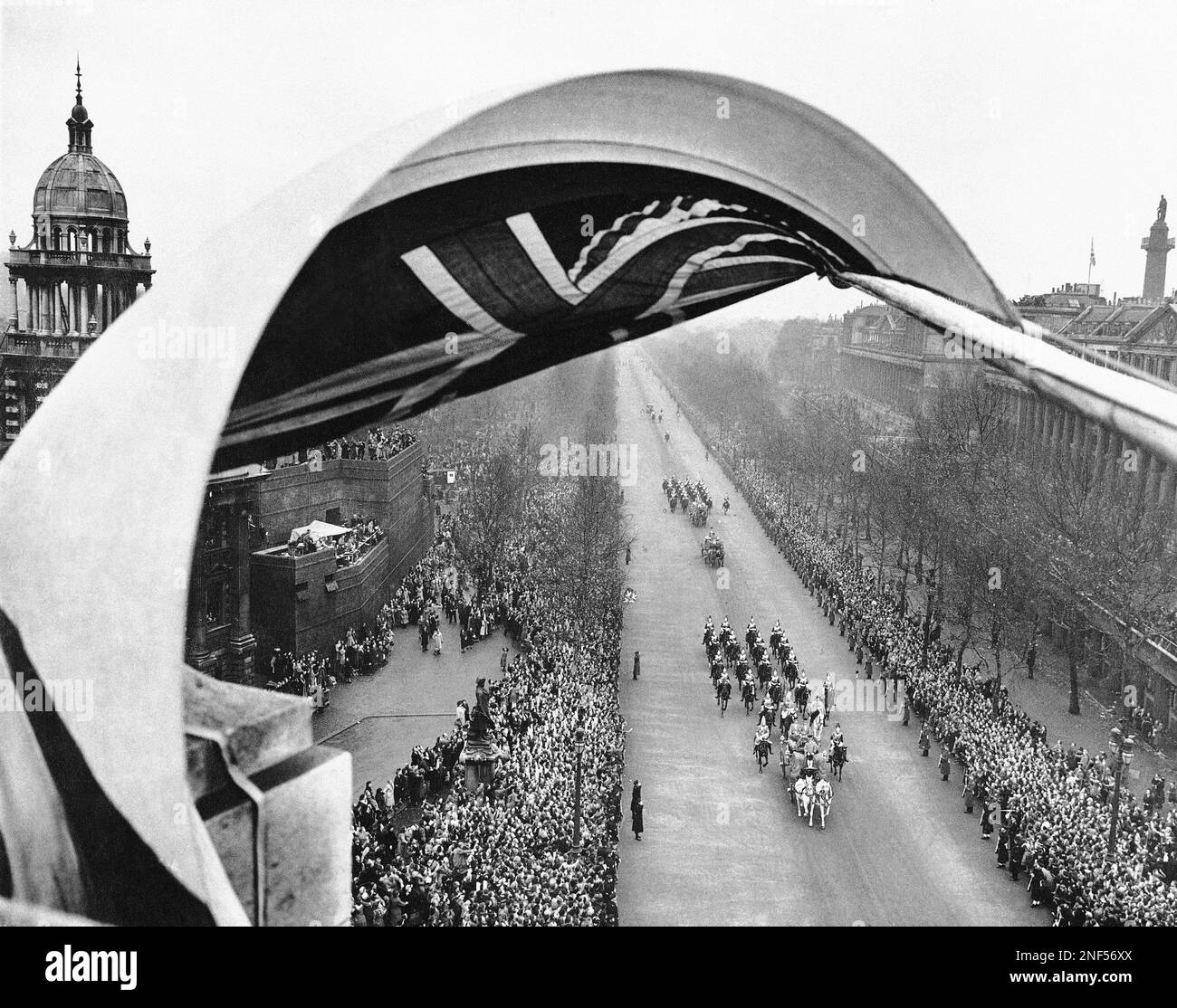 A Union Jack, whipping in the breeze from the Admiralty Arch, forms a ...