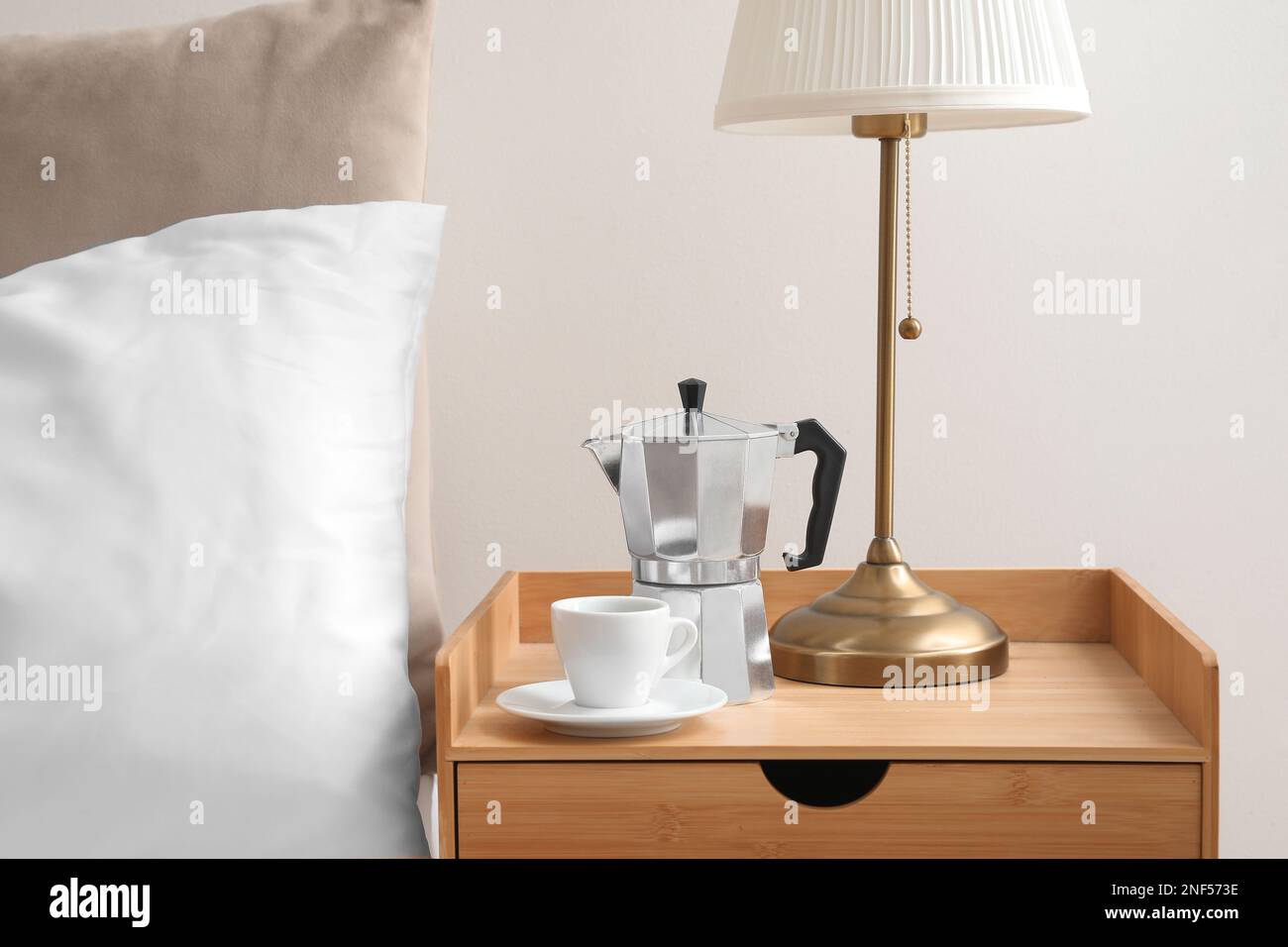 Geyser coffee maker and cup of espresso on nightstand near bed Stock ...