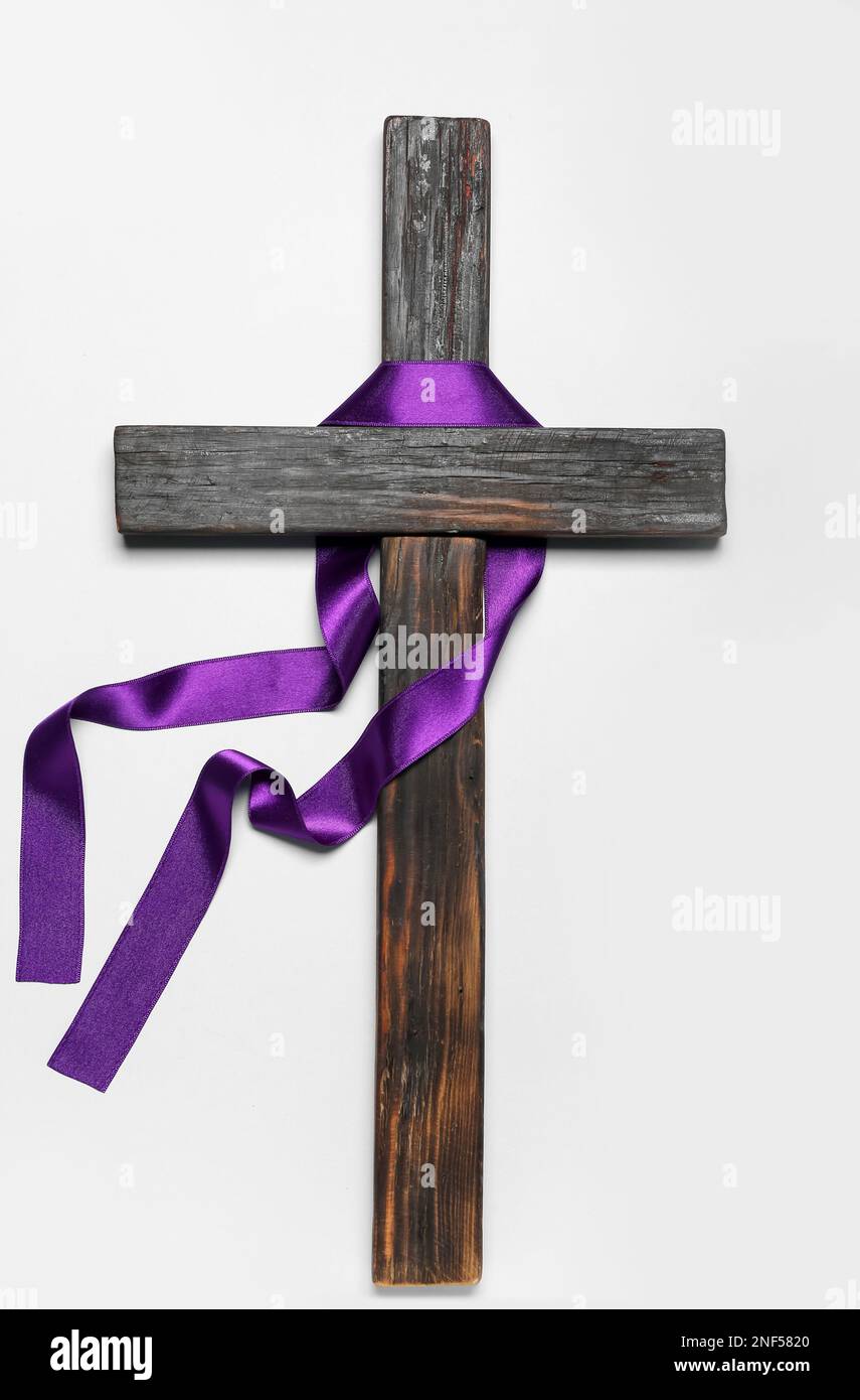 Wooden cross with purple ribbon on light background. Good Friday ...