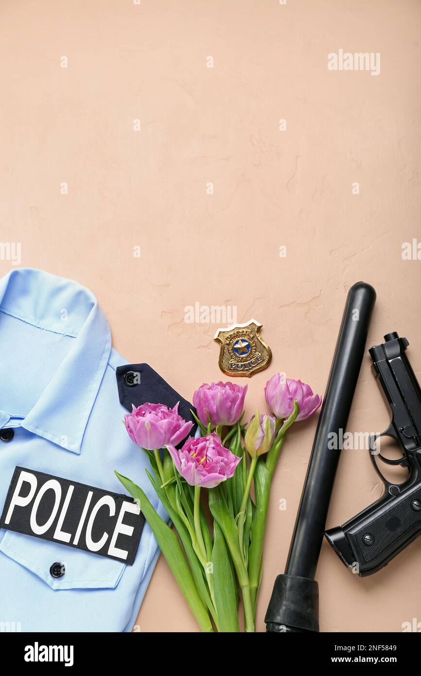 Policeman's uniform with items and tulips on beige background. Hello ...