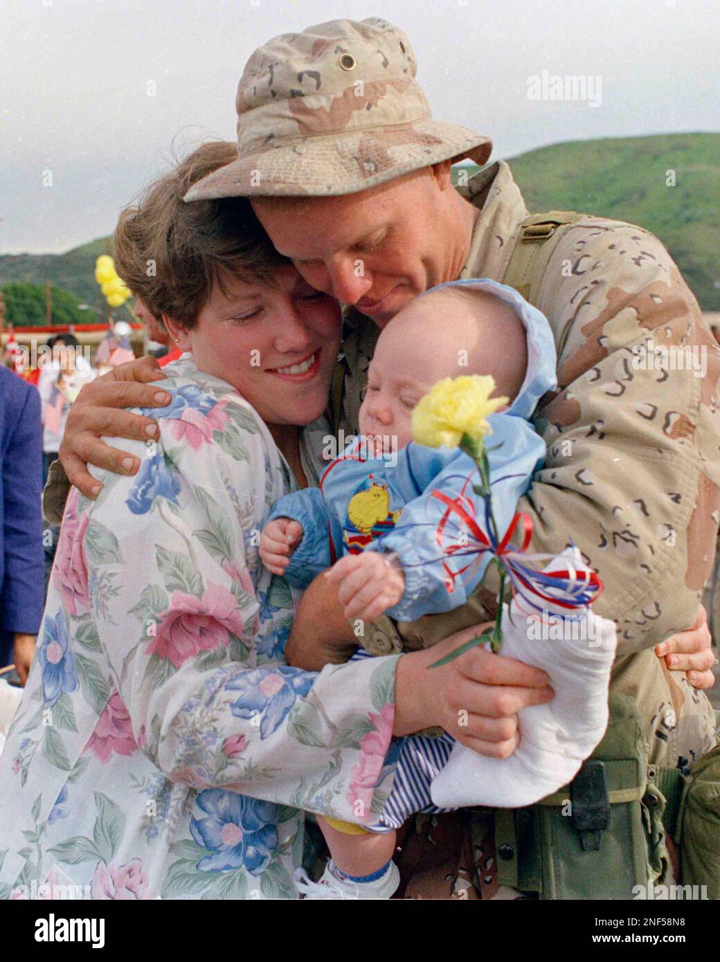 First Division Marine Brent Norseen hugs his wife Jamie as he holds ...