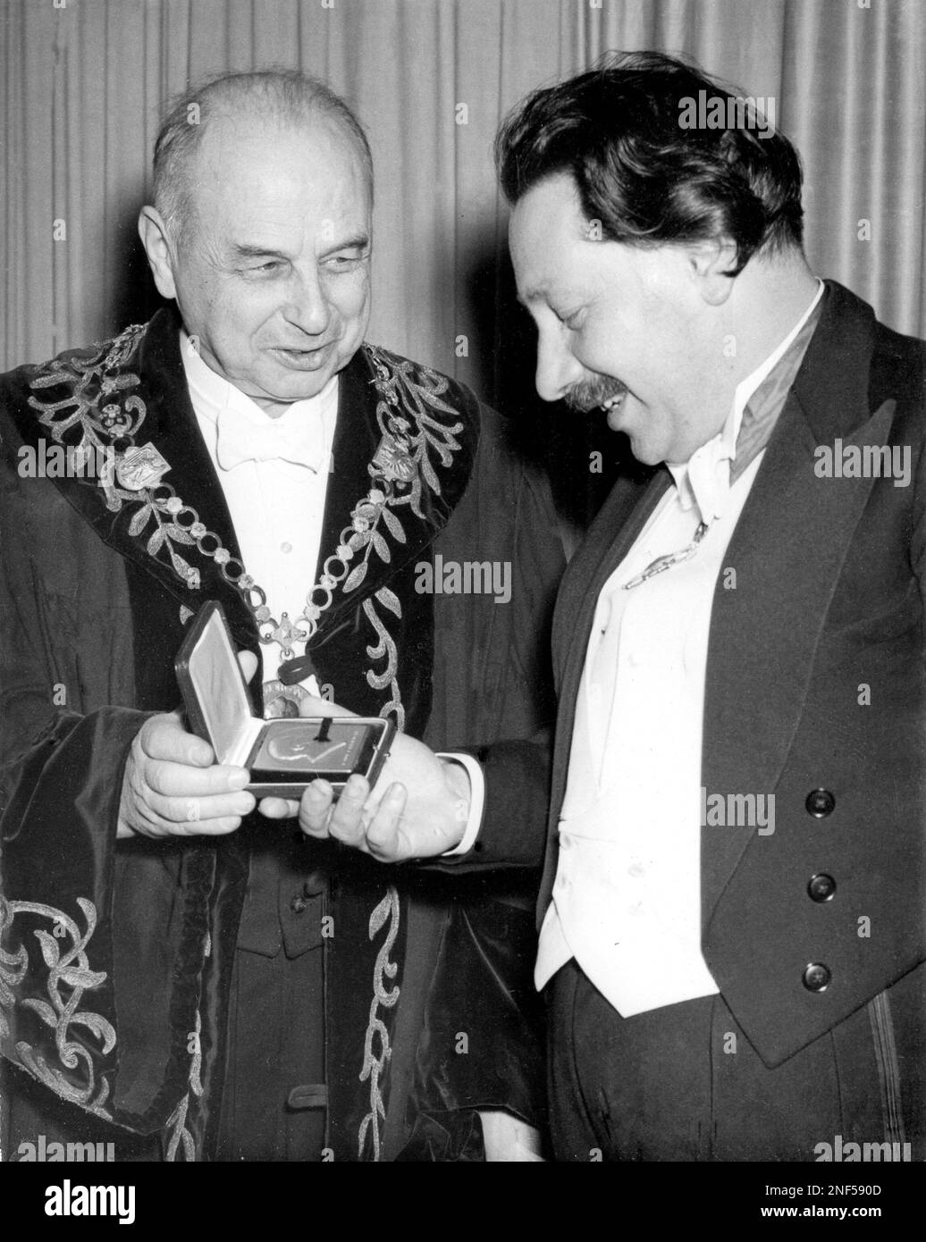Dr. Ernst Chain (right), Nobel Prize winner, smiles as he looks at the Paul Ehrlich gold medal ...
