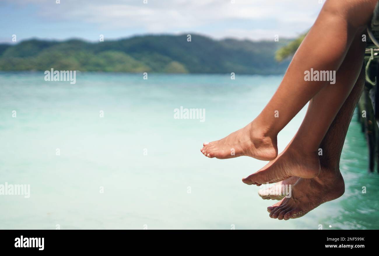 Sky above, sand below, peace within. an unrecognizable couple sitting ...