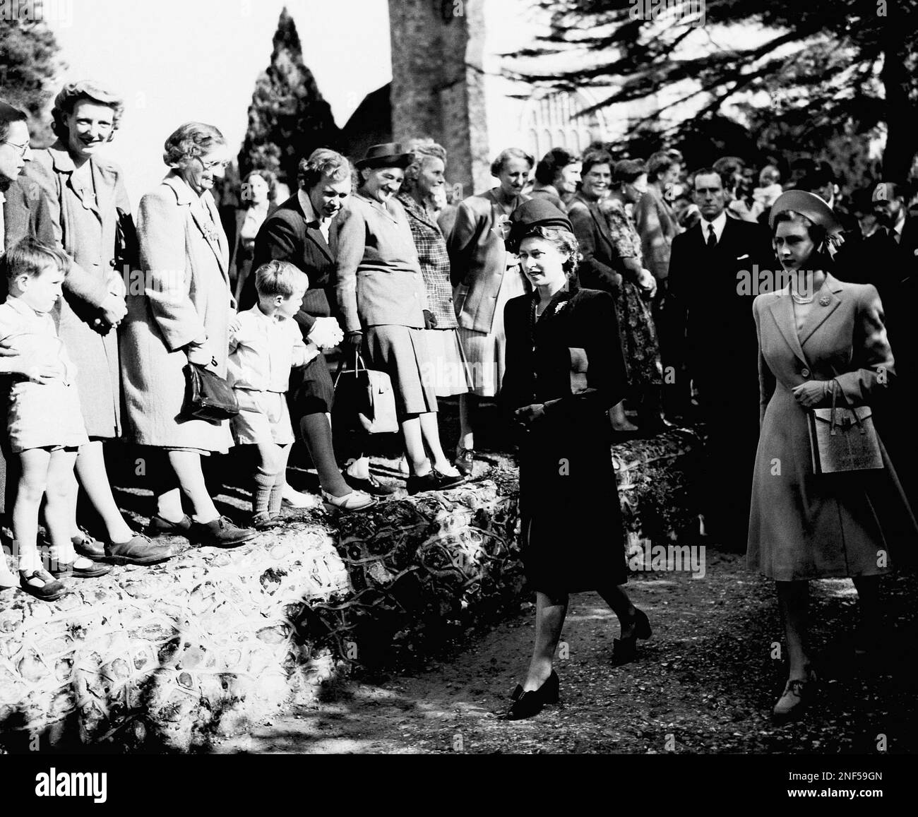 Princess Elizabeth, (left, dark coat and hat), and her sister, Princess ...