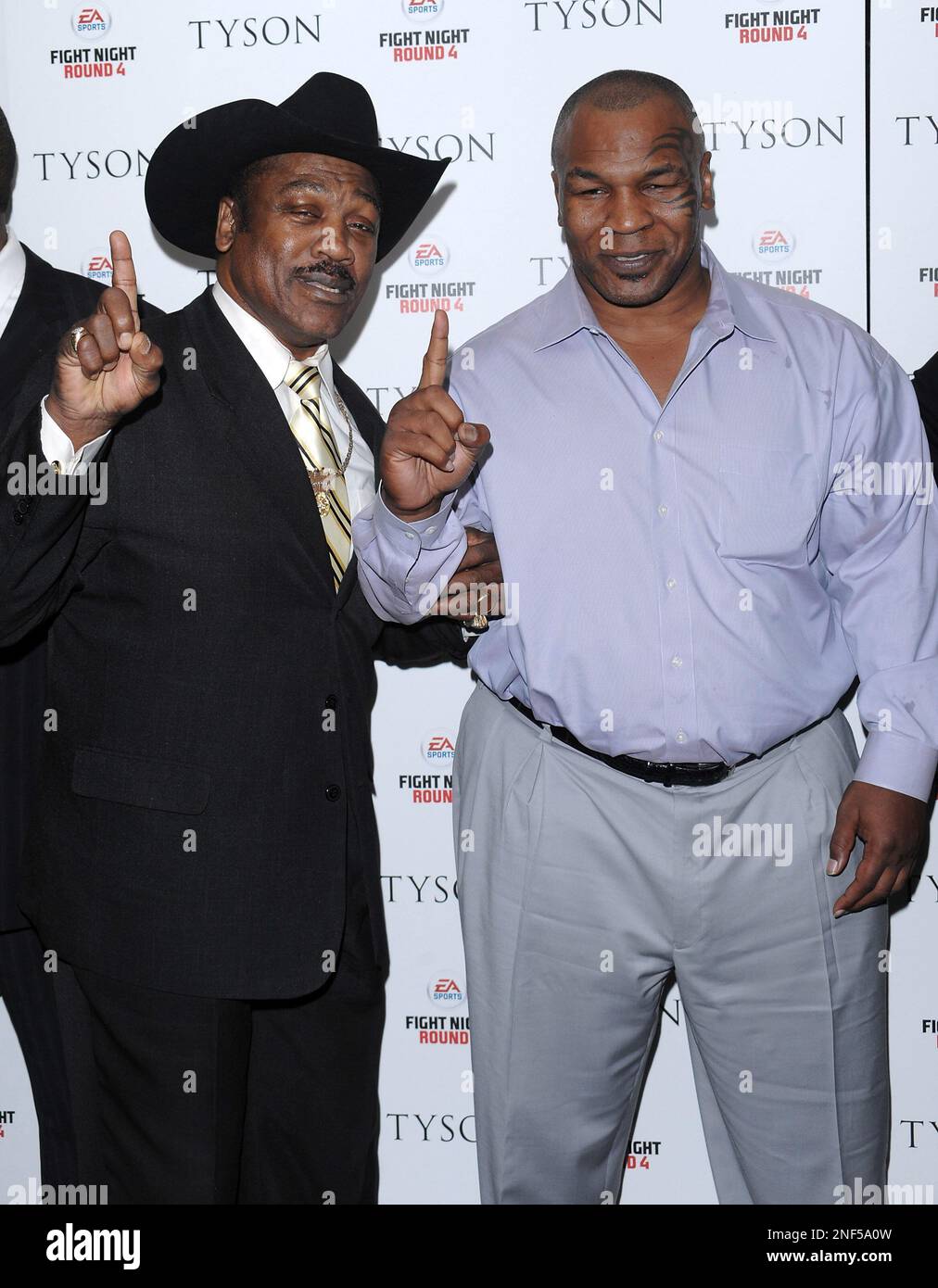 Former heavyweight boxing champions Joe Frazier, left, and Mike Tyson ...