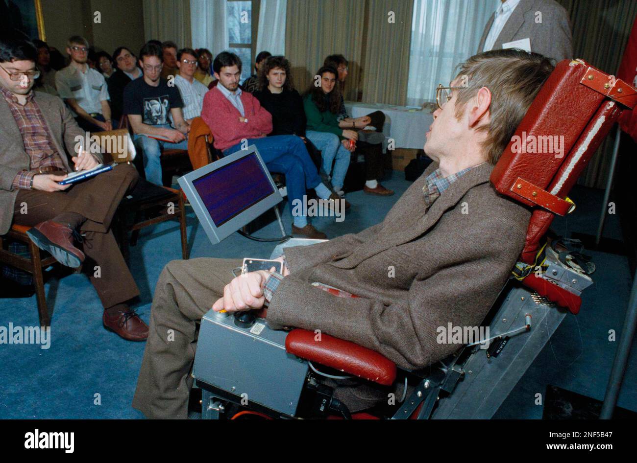 British astrophysicist Dr. Stephen Hawking is listened to closely by ...