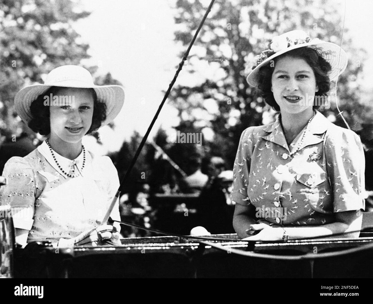 Princess Elizabeth, right, and Princess Margaret sit in their carriage ...