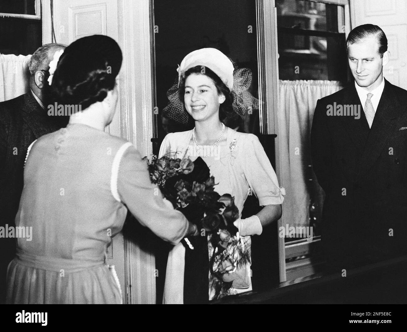 Princess Elizabeth, center facing camera, receives a bouquet of flowers ...