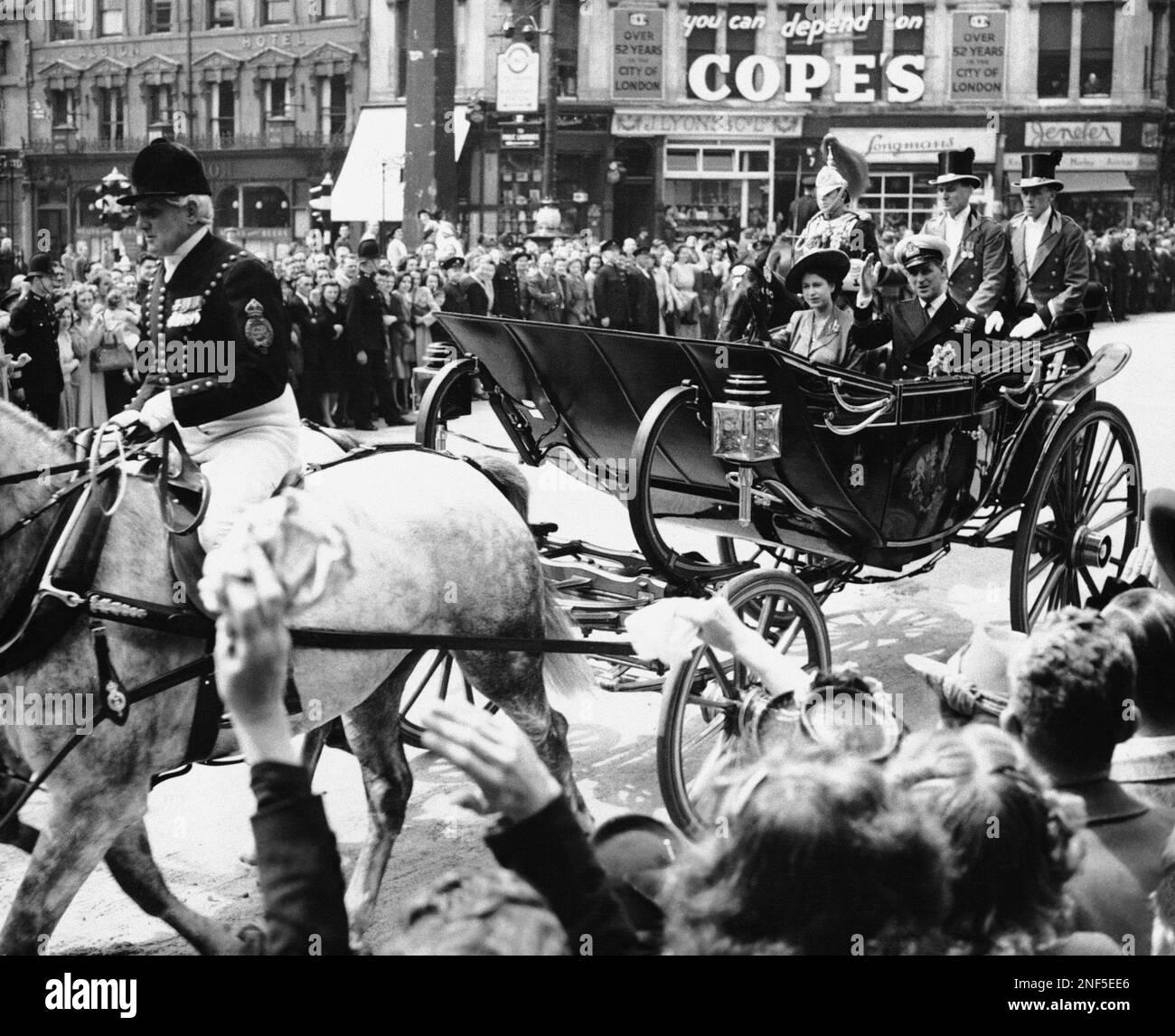 The Duke of Edinburgh and his wife, Princess Elizabeth, seated, wave ...