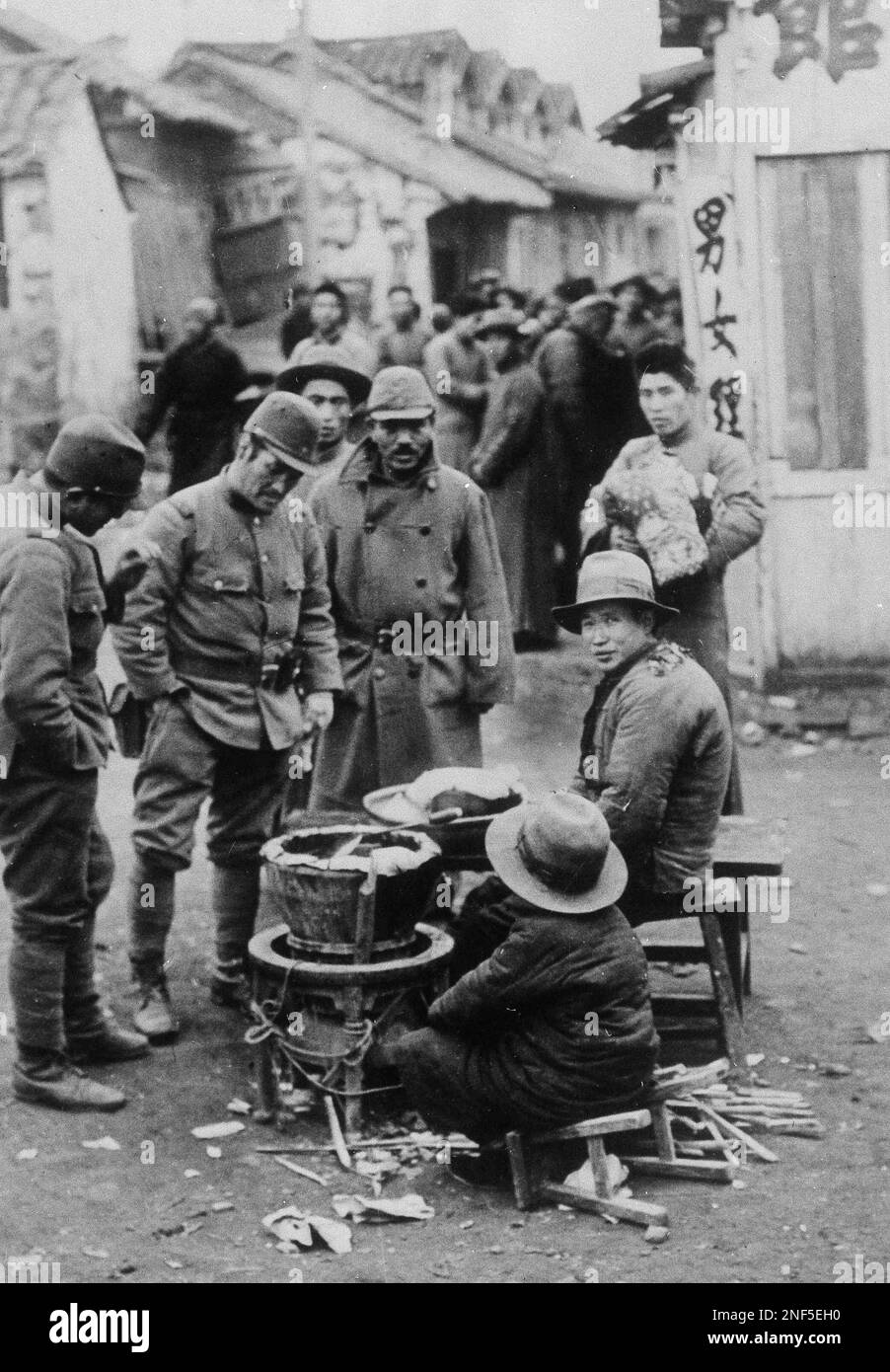 Japanese soldiers in Nanking, China bargain with a Chinese street food ...