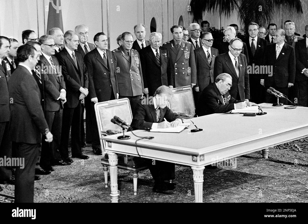 Soviet President Leonid Brezhnev, right at table, signs the documents ...