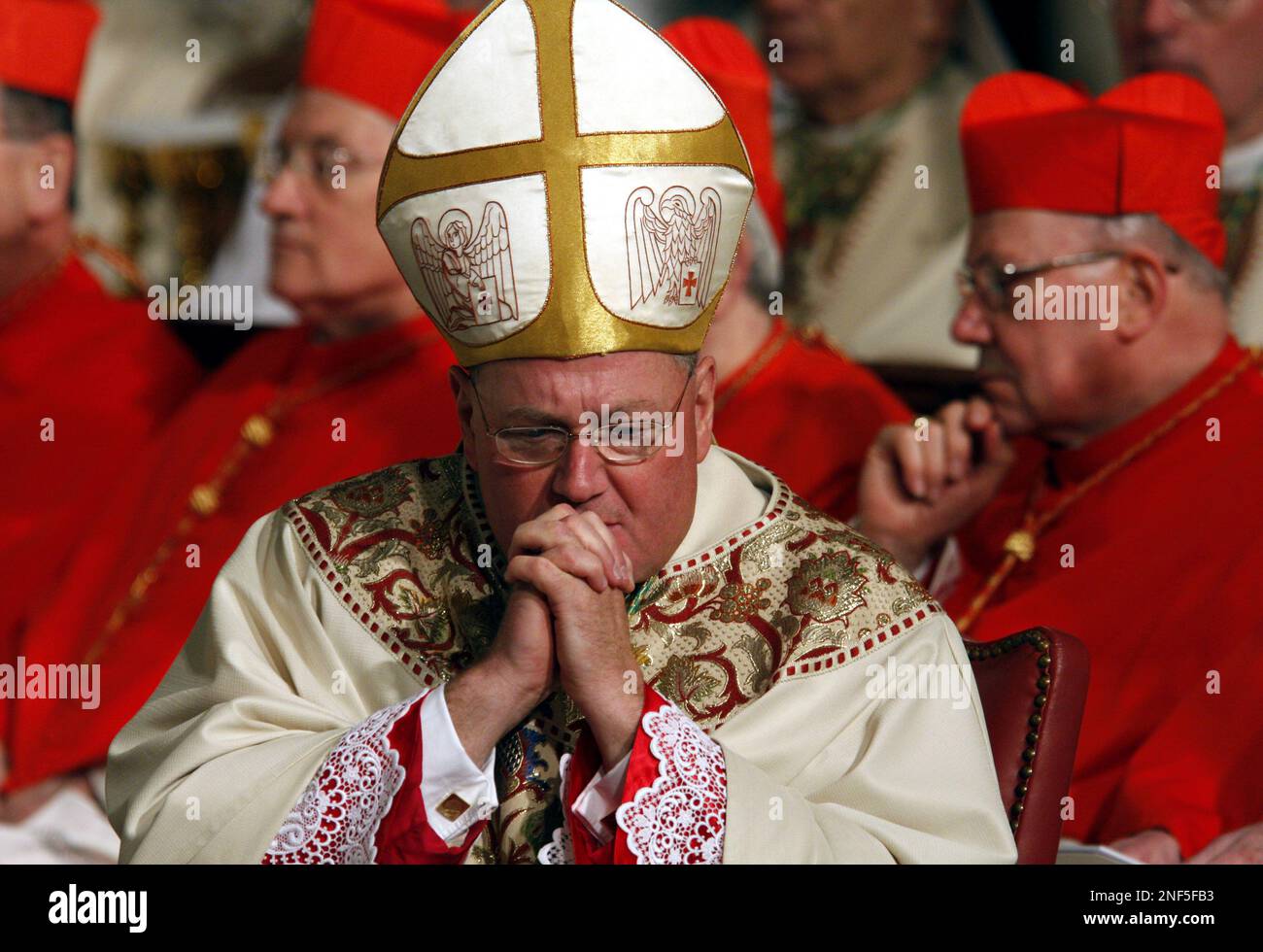 **POOL** Archbishop Timothy Dolan prays at the start of his Mass of ...