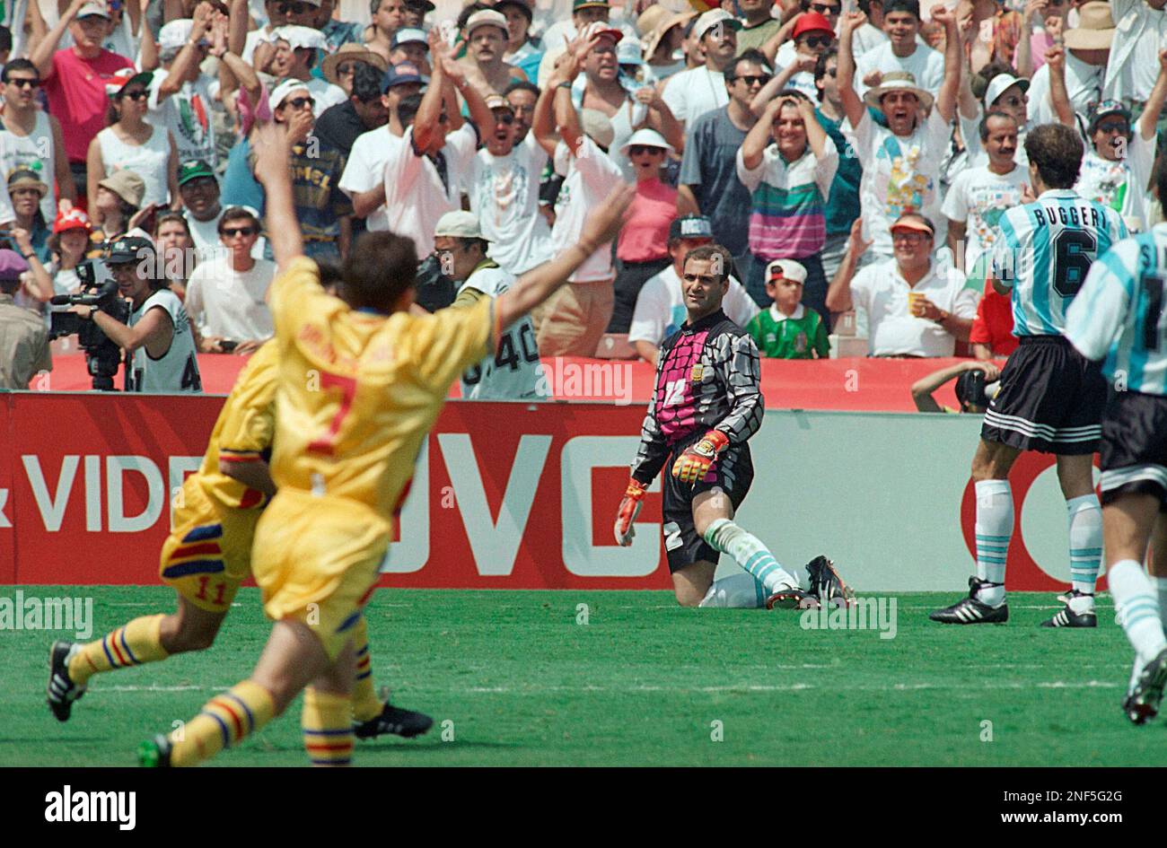 Romania's Dorinel Ionel Munteanu (7) celebrates teammate Gheorghe Hagi ...