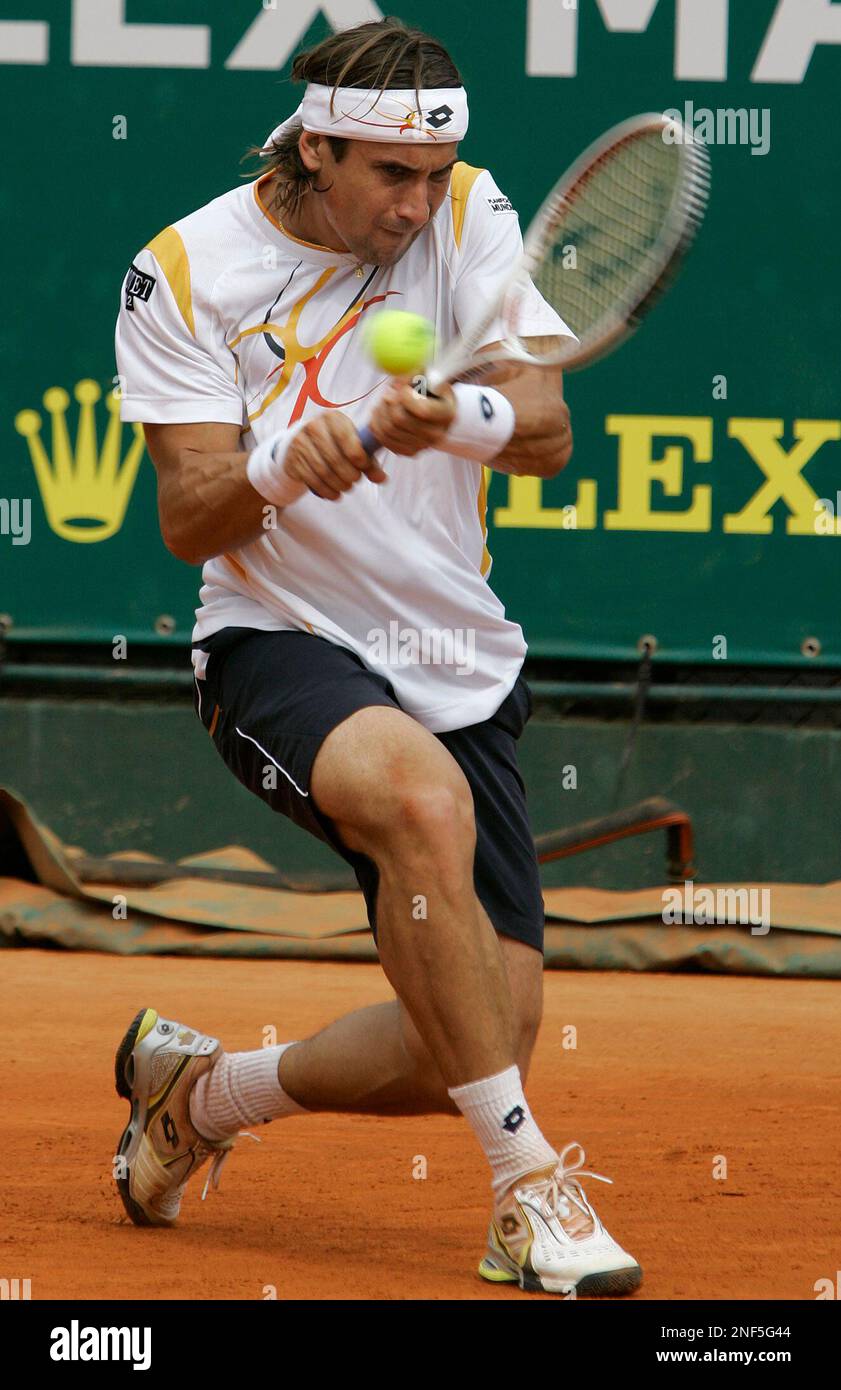 David Ferrer of Spain plays a return to Marc Gicquel of France during ...