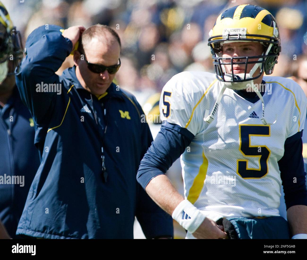 Michigan head coach Rich Rodriguez, left, stands behind freshman ...