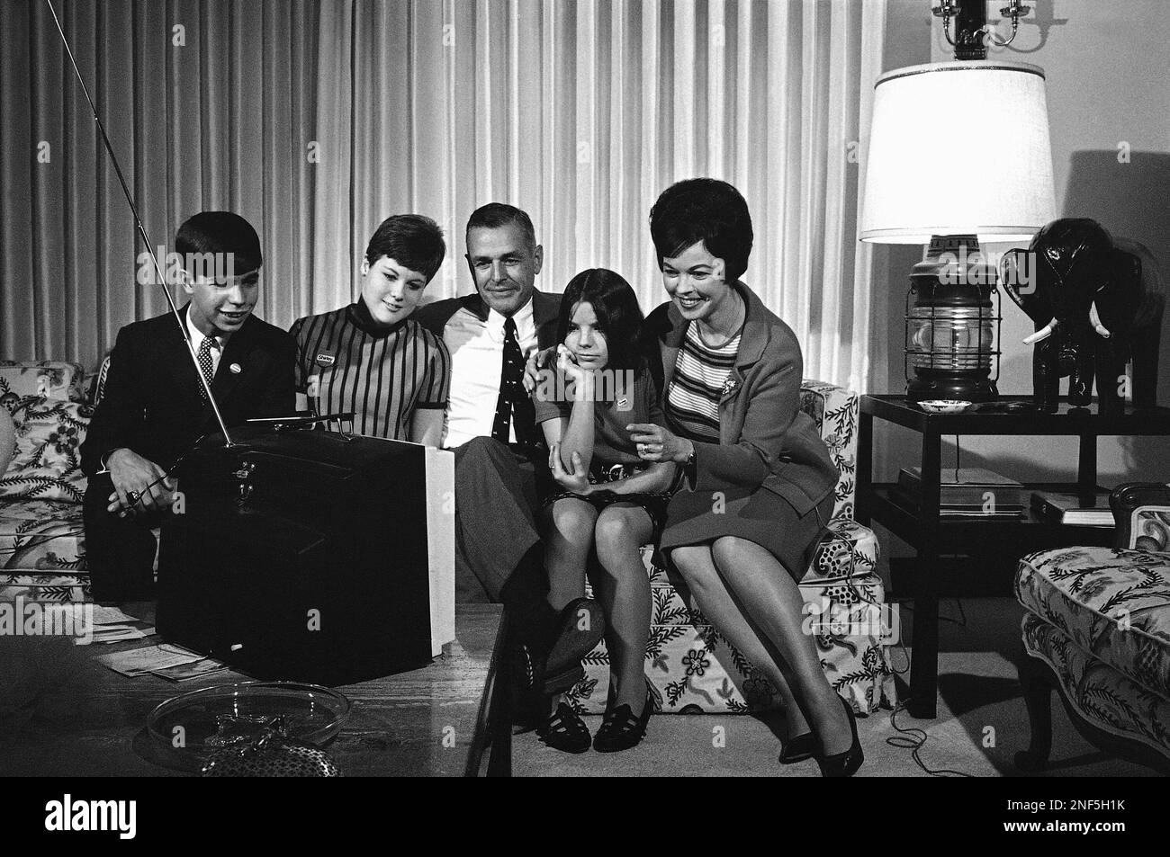 Shirley Temple Black and her family pose in front of the television set ...