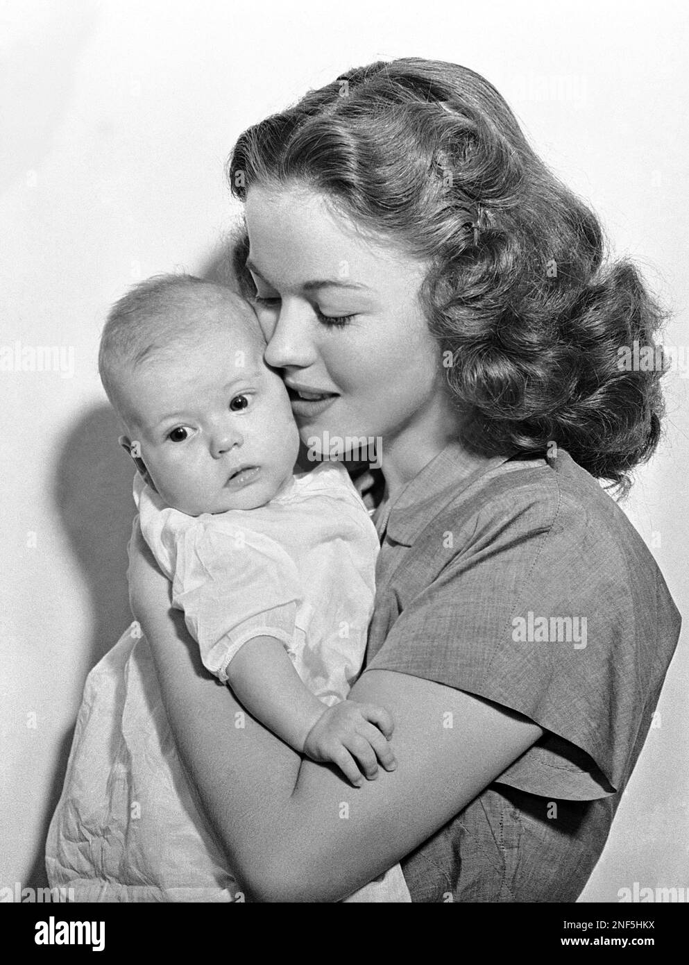 Three-month-old Linda Susan Agar, daughter of Shirley Temple, poses for her first picture with ...