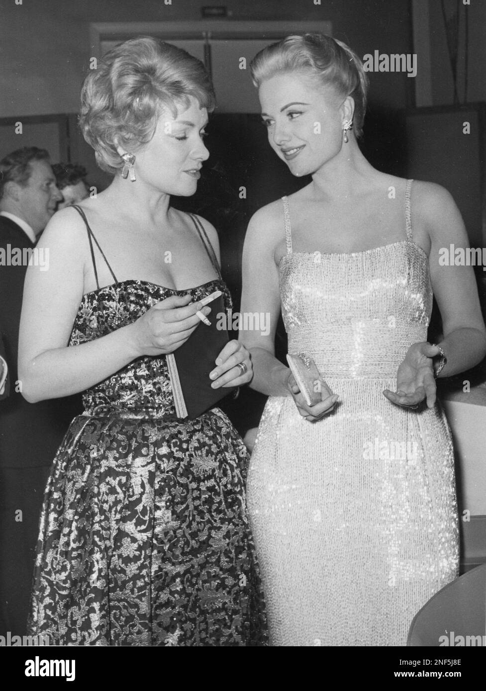 West German actress Ruth Leuwerik, smoking a cigarette, left is ...