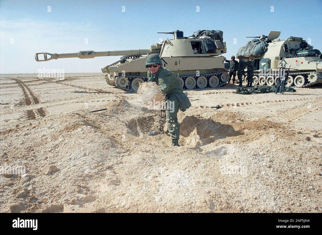 Pfc. Gregory Harvey of Sacramento, Calif., digs a foxhole in the Saudi ...