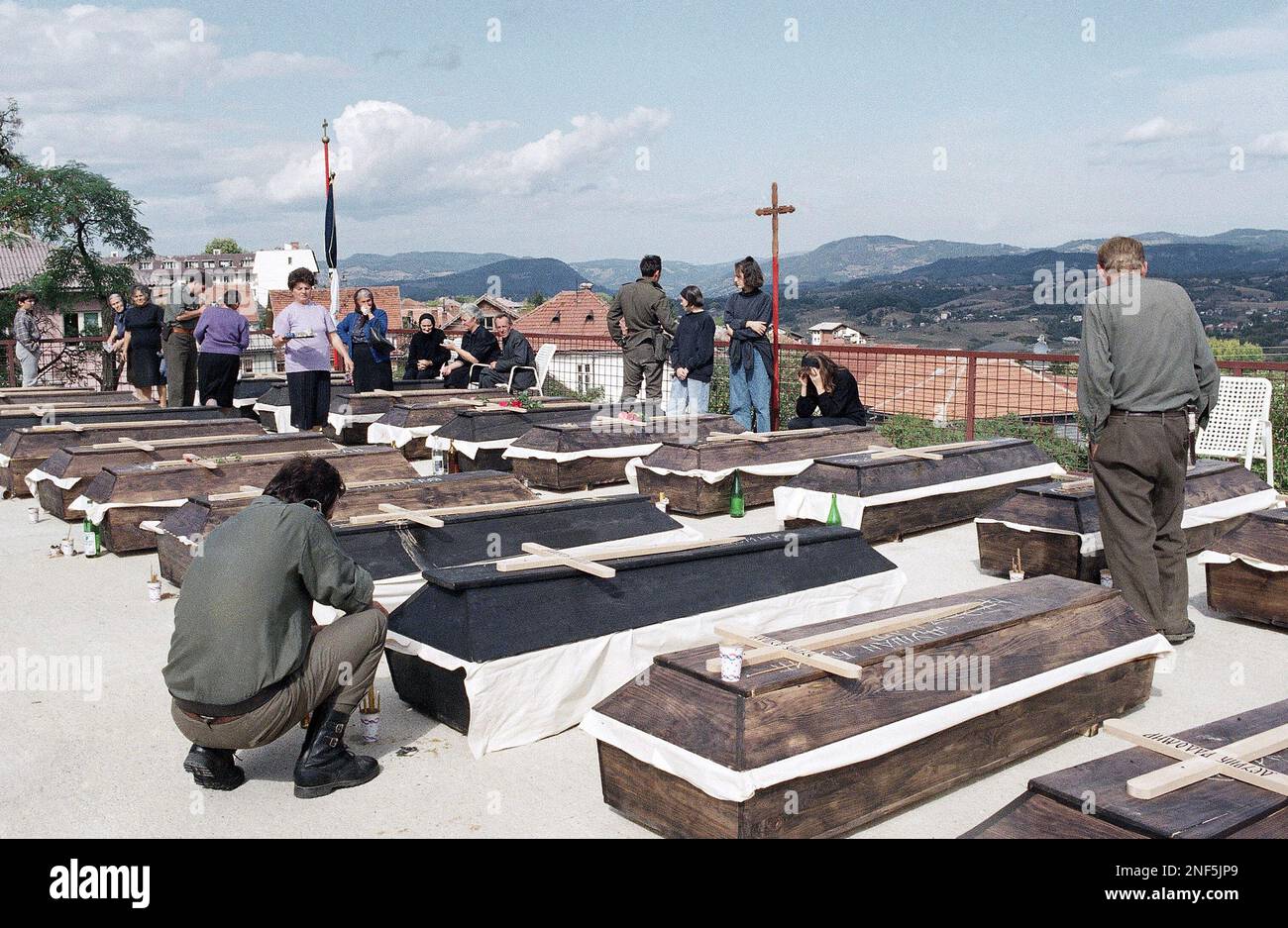 Two Serbian soldier look at coffins with the remains of 28 Serbian ...