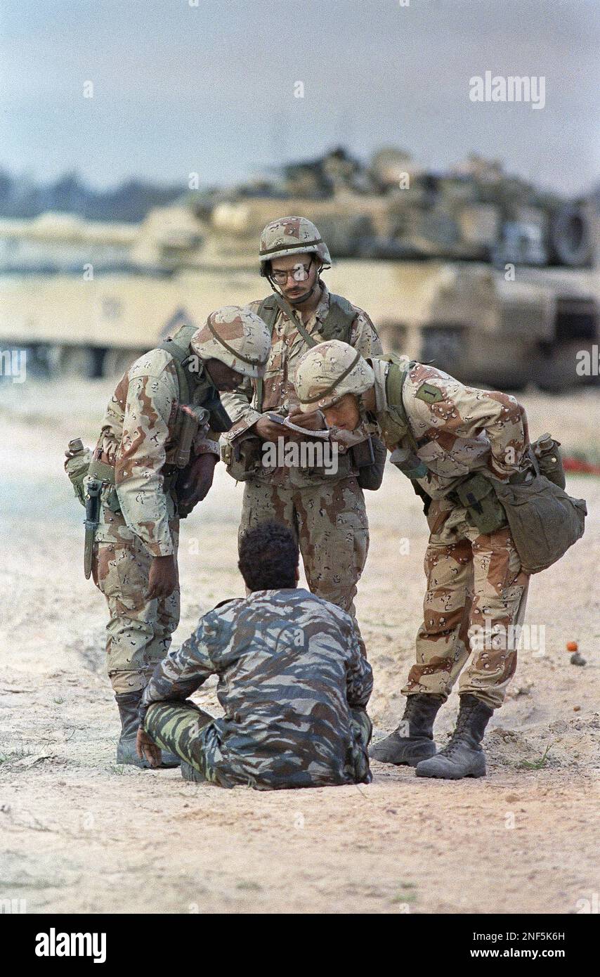 American soldiers question an Iraqi soldier who was among a group of ...
