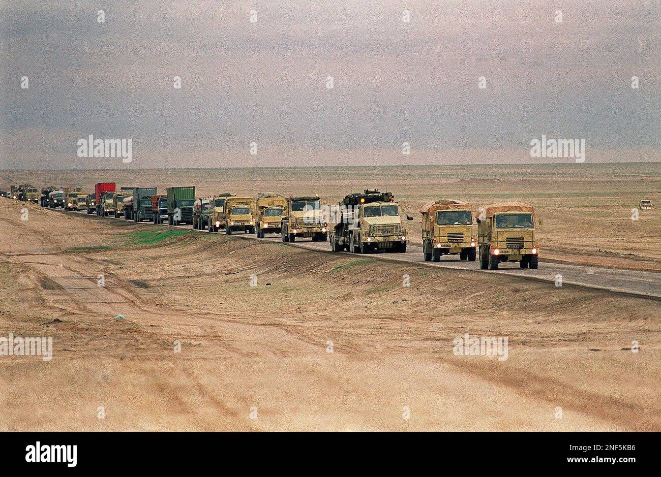 British and American military vehicles cross the northern Saudi desert ...