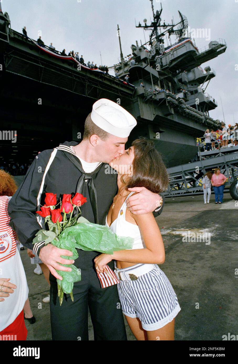 Alicia Bowers gives her husband Marc a kiss on the dock after the U.S.S ...