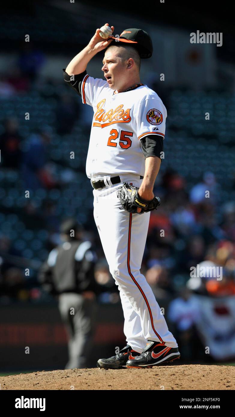Baltimore Orioles pitcher Brian Bass reacts after giving up his second ...