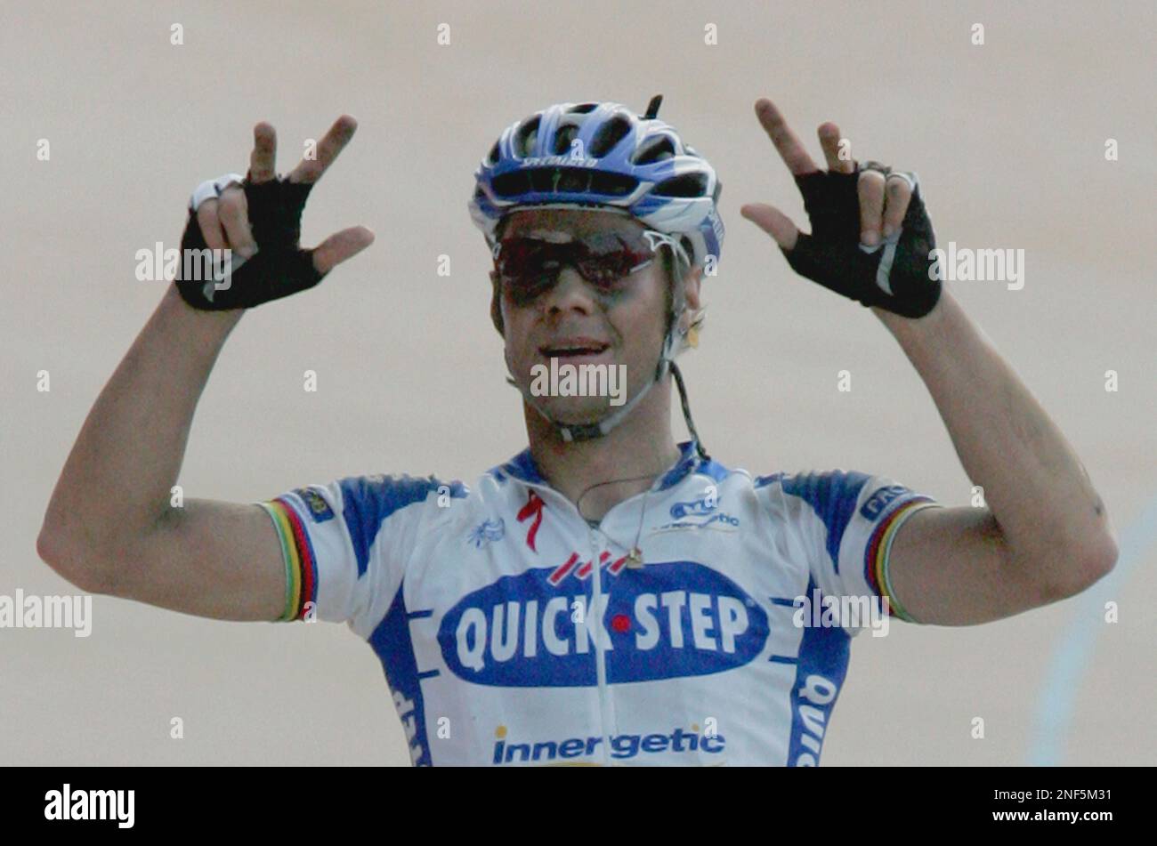 Belgium's Tom Boonen of the Quick Step team reacts as he crosses the ...