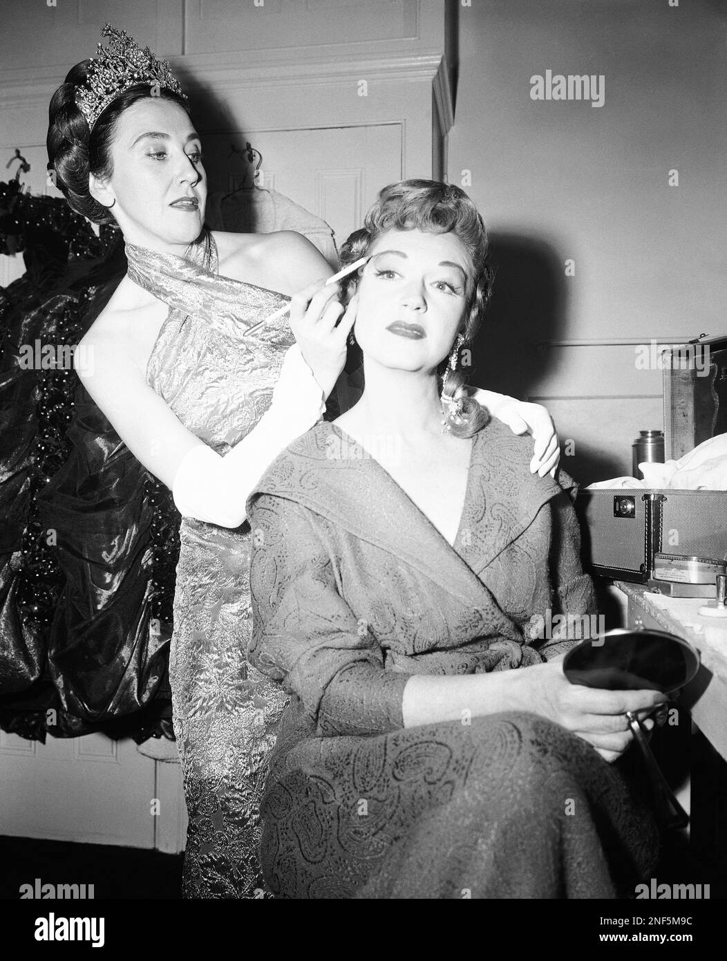 Mezzo Soprano Rise Stevens, seated, gets some help with makeup for her ...