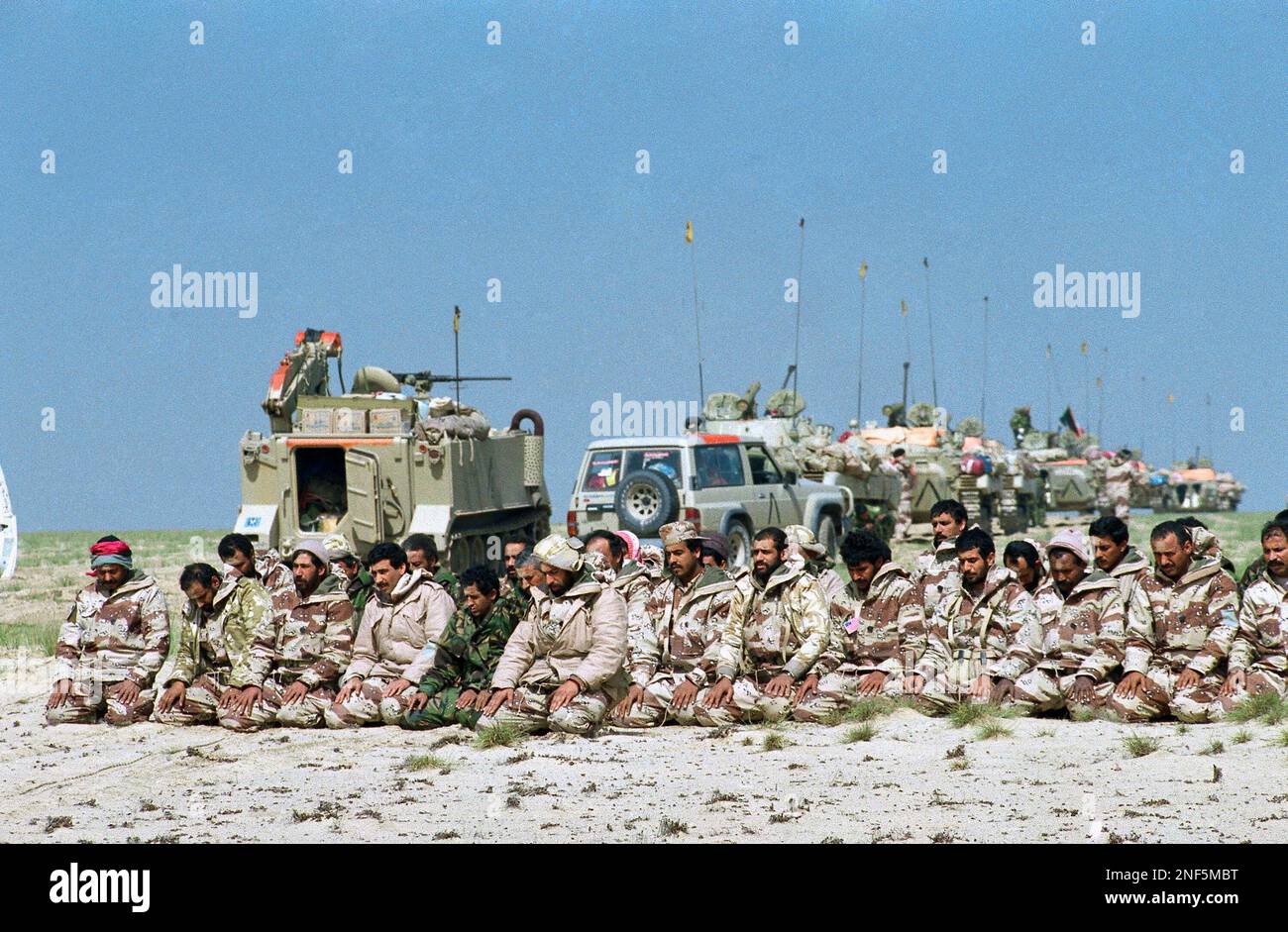 Kuwaiti soldiers pause to pray inside their homeland as a Kuwaiti ...
