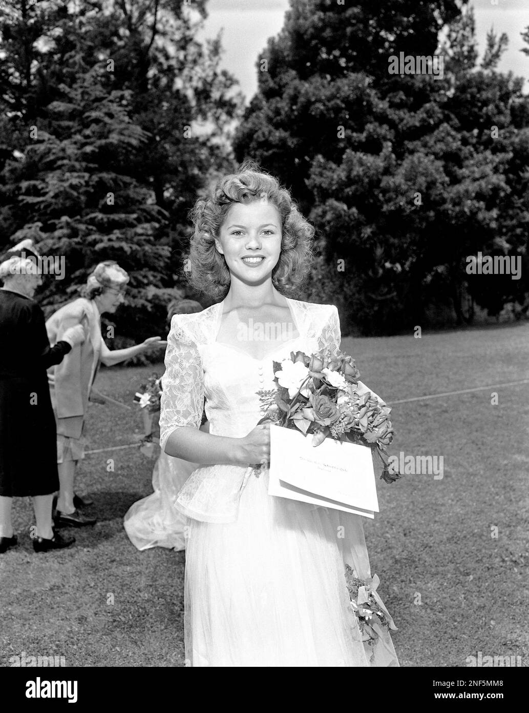 Shirley Temple, passing another milestone in her career, proudly holds ...