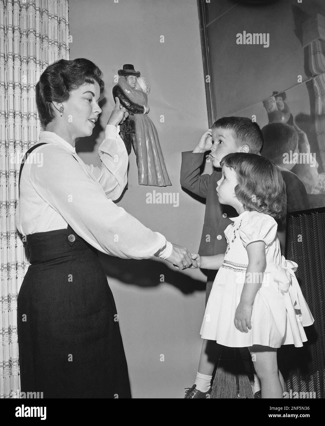 While her son Charles, 5, scratches his head in wonder, Shirley Temple ...