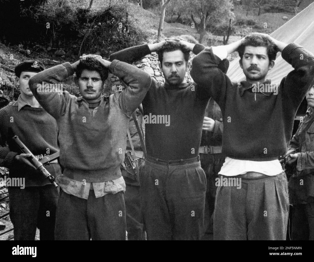 Hands on heads, three men of the Eoka organization captured in the ...