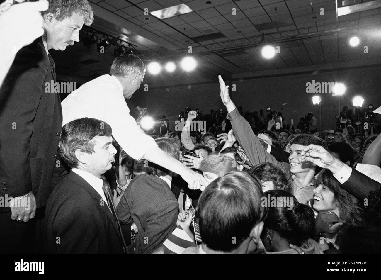 Walter Mondale, left, leans out to greet the crowd at a post-debate ...