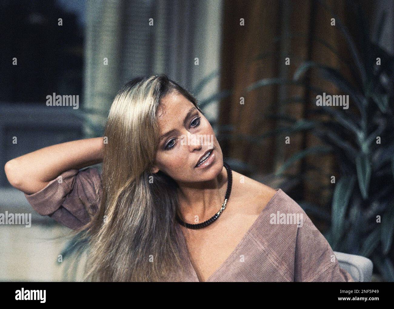 Photo of Farrah Fawcett-Major shows her handling her hair while ...