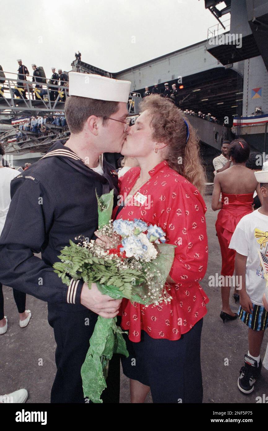 Alan Lessard kisses his wife, Judi, on the pier after returning from ...