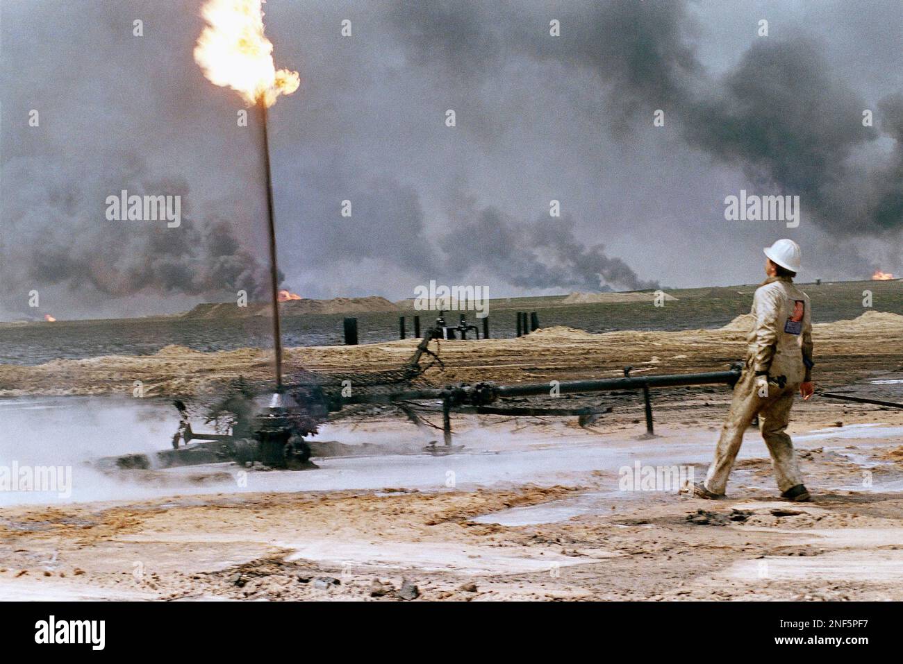 Mike Petrus of Denison, Texas steps back as a flaming rag he just ...