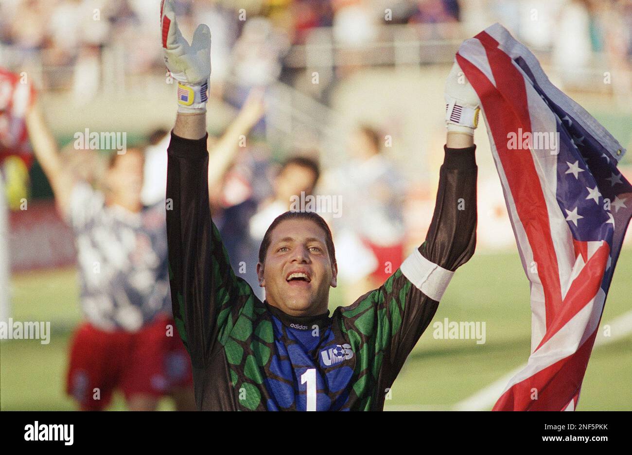 United States goalkeeper Tony Meola celebrates with the American flag ...