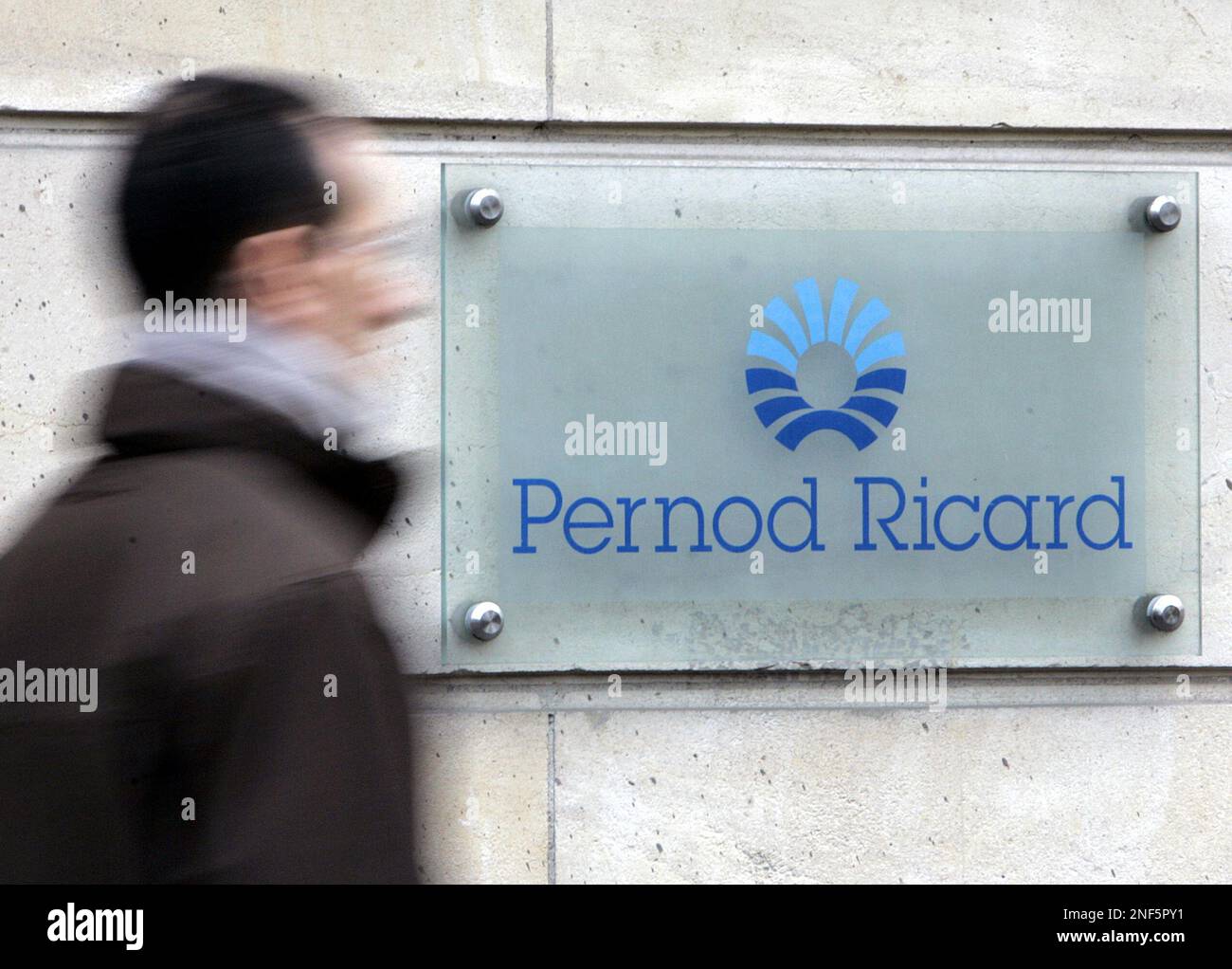 ** FILE ** In this March 31, 2008 file photo, a passerby walks past the ...