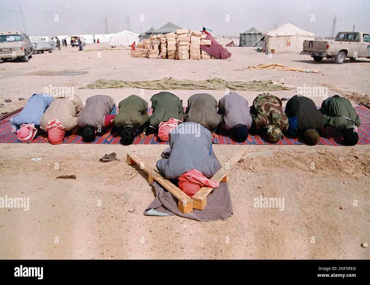 Kuwaiti soldiers kneel to pray during one of five daily prayers at a ...