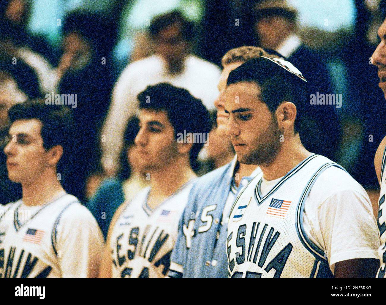 Members of Yestiva University basketball squad take part in a moment of ...