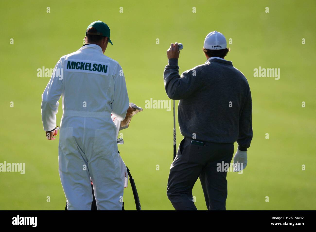 Phil Mickelson with his caddie James Mackay during his practice round for the Masters golf ...