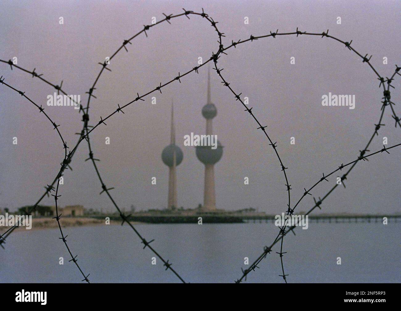 The water towers that dominate the Kuwait City skyline are framed by ...