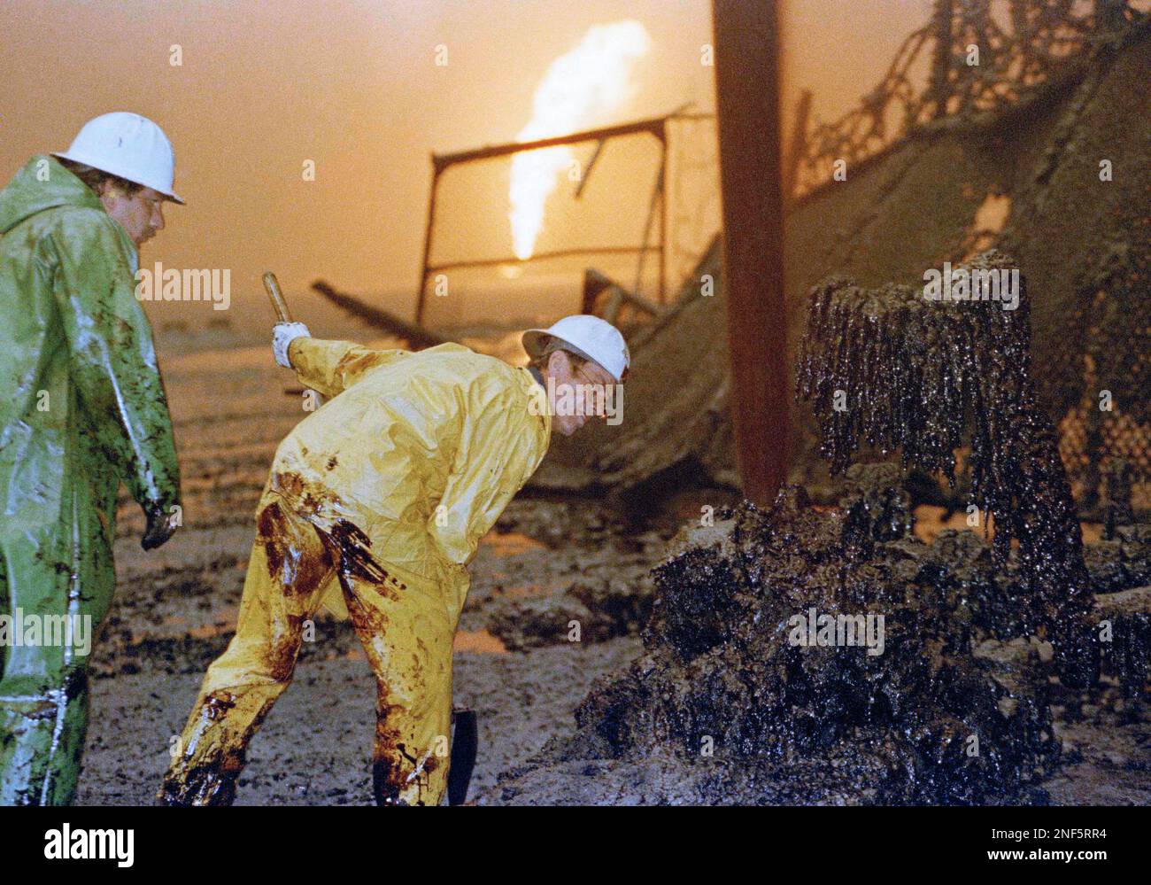 Ace Barnes, 62, of Odessa, Texas, examines the buildup of coke, a ...