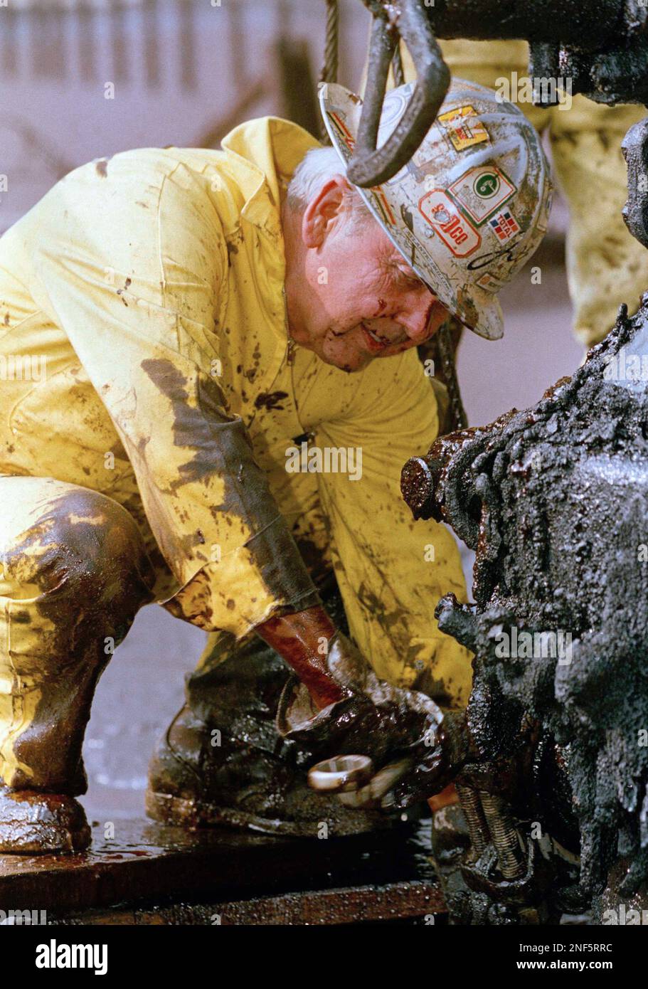 Joe Bowden, head of Wild Well Control Co., of Spring, Texas, tightens a ...